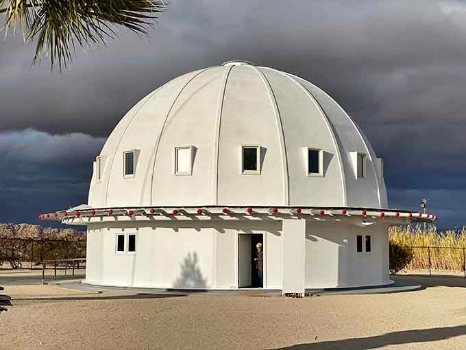 When storm clouds gather over this white dome, it looks like a UFO considering whether to stay or go.
