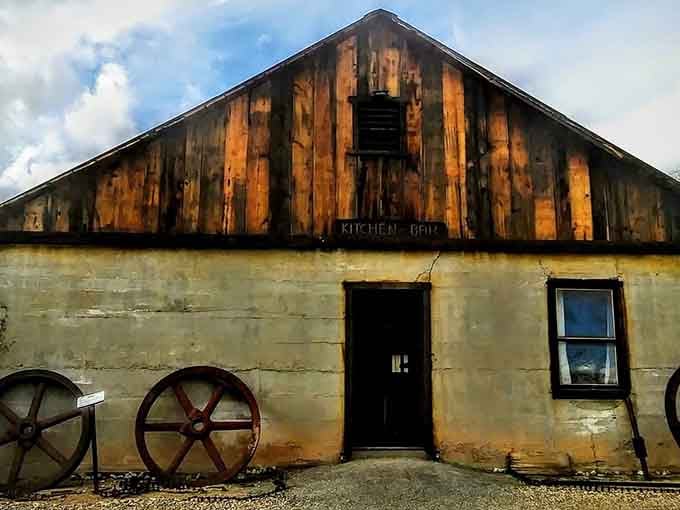 The old kitchen building wears its age proudly, with weathered wood and rusty wheels guarding forgotten mining camp memories.