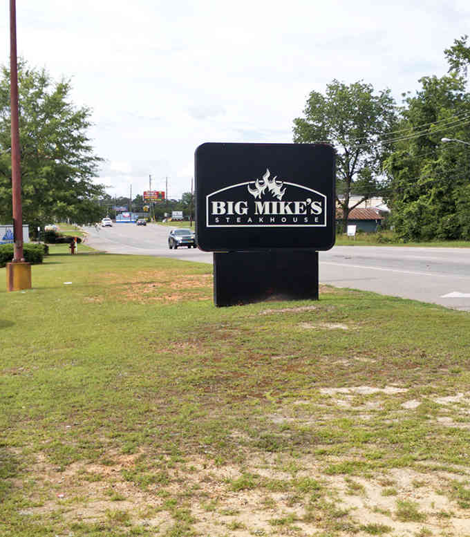 That bold roadside sign stands like a beacon guiding steak lovers to their next great meal.