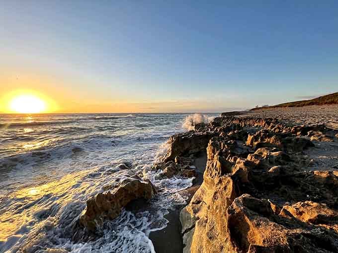 Golden hour transforms these ancient limestone formations into glowing sculptures as waves crash against weathered rock.