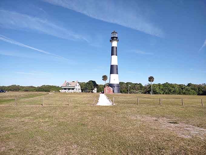 The brick pathway leads you straight to history, where the keeper's house and tower stand ready for exploration.