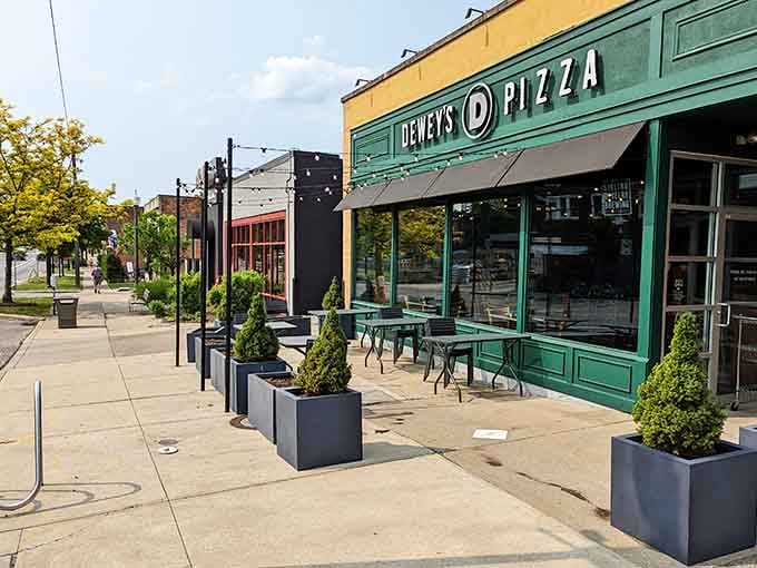 Outdoor dining with planters and shade creates the kind of neighborhood spot where everyone becomes a regular eventually.