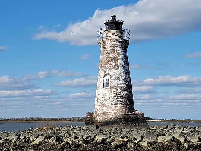 Weathered and timeless, Cockspur Island Lighthouse near Savannah stands above rocky shores, guiding coastal travelers with historic Southern charm.