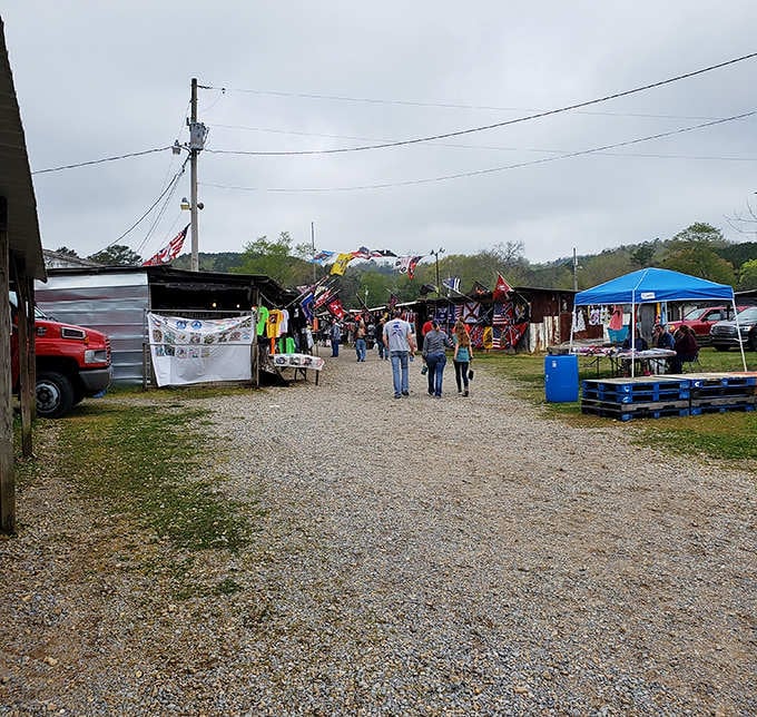 Shoppers stroll the pathways between colorful flags and vendor stalls like explorers charting new territory for treasure.