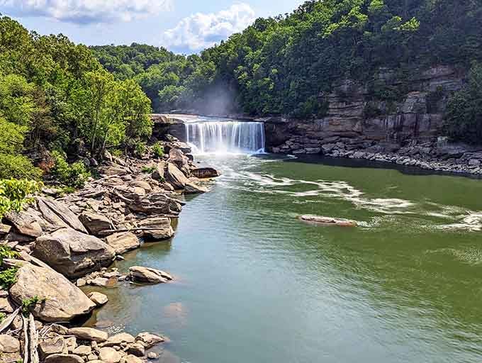 The layered stone cliffs frame this waterfall like nature's own picture frame, perfectly composed without any Instagram filters needed.
