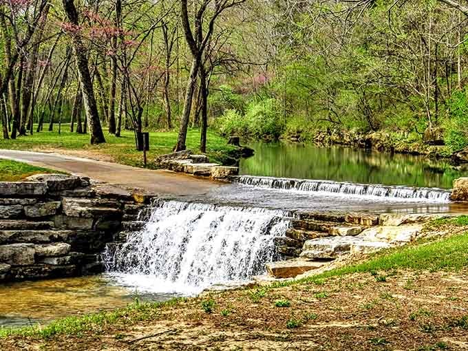 Cascading waterfalls tumble over limestone ledges while spring greenery creates a scene worthy of your best camera work today.