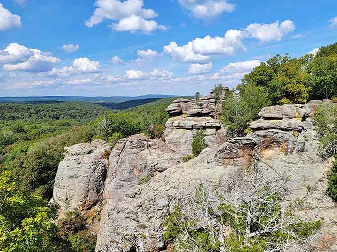 Those weathered stone pillars reach toward puffy clouds, creating a natural cathedral that's been standing for millions of years.