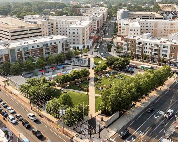 Green spaces and gathering spots create community hubs where generations connect over concerts and farmer's markets.