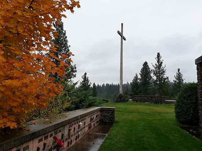 Autumn leaves frame the columbarium walls where memories are preserved, peaceful and dignified against the evergreen backdrop beyond.