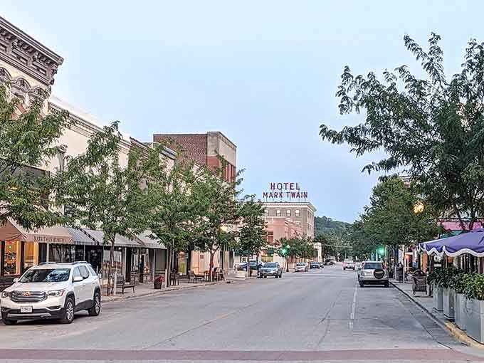The Hotel Mark Twain sign rises above quiet streets where literary history whispers from every corner and cafe.