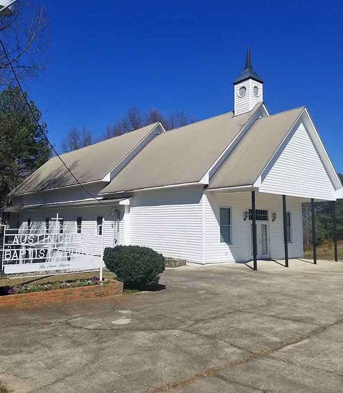 Classic white church architecture reminds you that some communities still value tradition, fellowship, and Sunday potlucks that last hours.