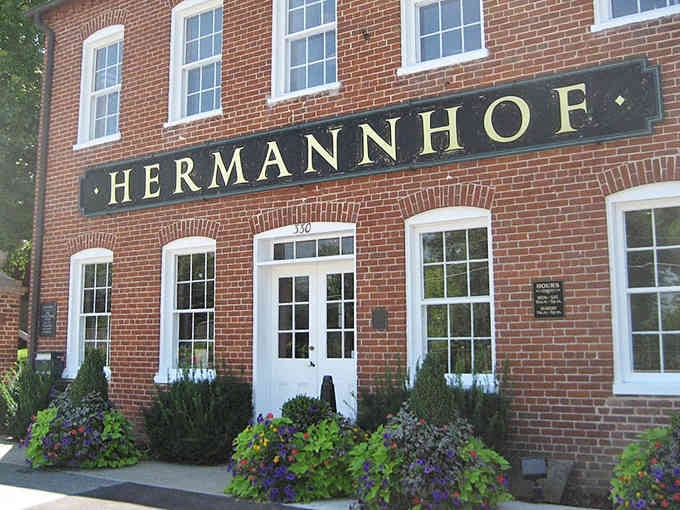 The Hermannhof sign welcomes visitors to experience German heritage preserved in beautiful brick and pristine white trim.