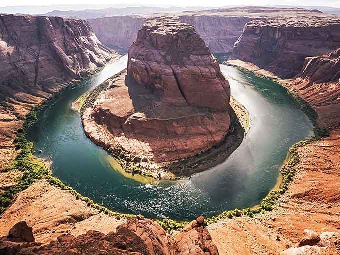 The Colorado River drew a perfect horseshoe around this towering rock, showing off after millions of years of practice.