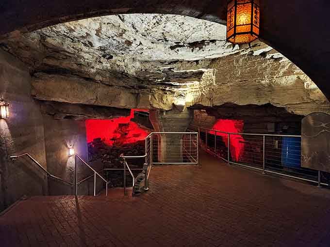 Dramatic red lighting transforms ancient rock into something from a science fiction movie set deep below ground.