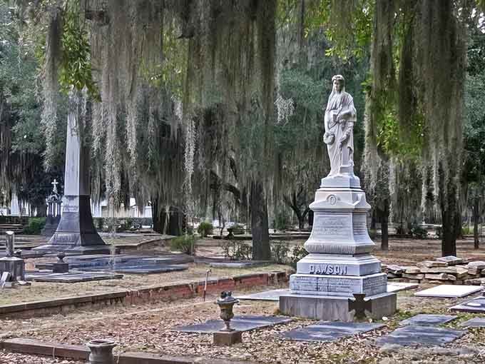 White monuments stand sentinel among the draped trees, their stories whispered through centuries of Southern twilight.