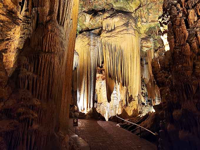 Golden limestone cascades create a subterranean wonderland where every stalactite tells a million-year story of patient geological artistry.