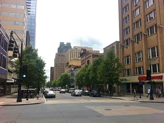 Tree-lined streets lead into the heart of downtown where glass towers reflect puffy clouds like nature's own mirror show.