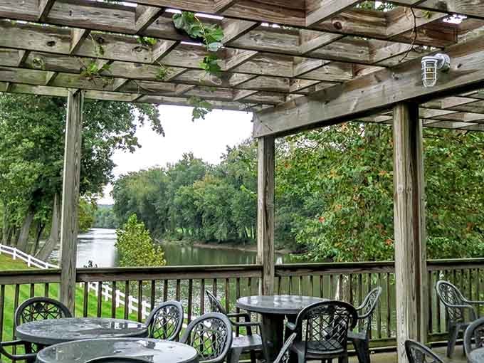 Rustic pergola dining where weathered wood frames views of endless green countryside and gentle breezes.