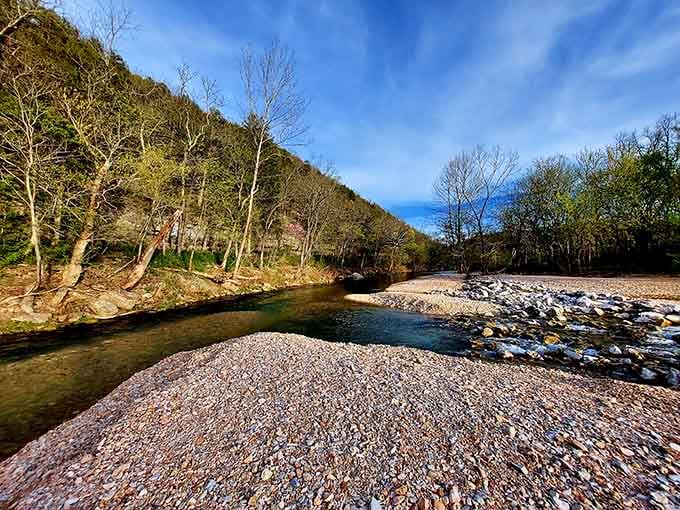 Crystal-clear water dances over smooth river stones, creating nature's own meditation soundtrack in this peaceful Ozark sanctuary.