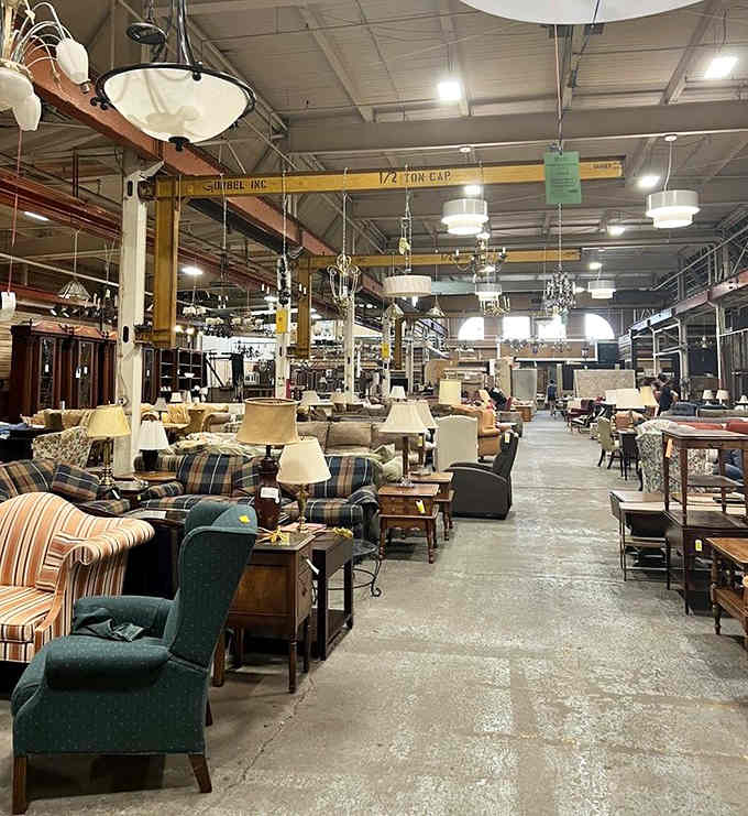 Inside this industrial cathedral of salvage, vintage chandeliers dangle overhead like stars waiting to light someone's new home.