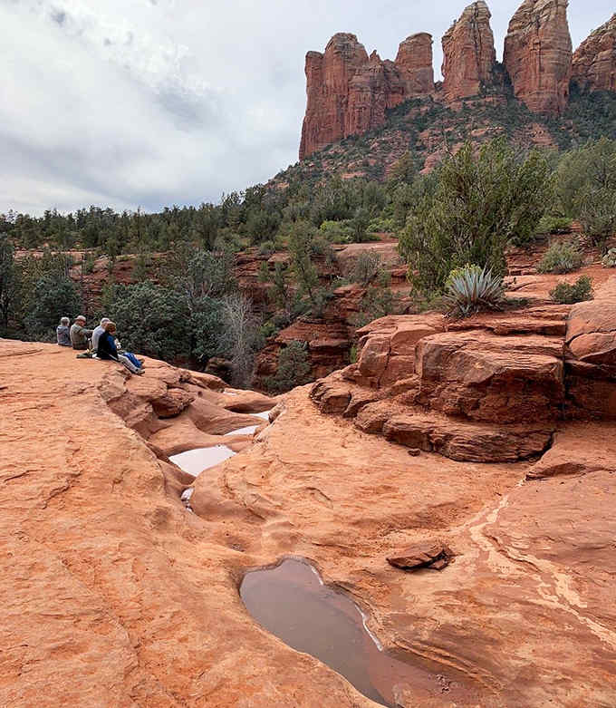 Sacred pools carved in crimson stone offer perfect mirrors reflecting Sedona's towering cathedral spires above.