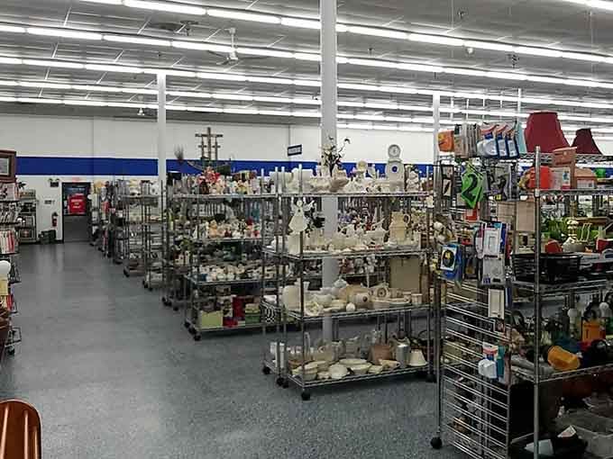 Gleaming glassware and vintage treasures line metal shelves in pristine rows, waiting for their second act.