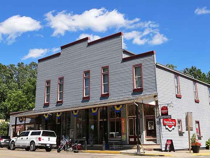 Patriotic bunting decorates the vintage storefront, celebrating small-town America with genuine pride and cheerful charm.