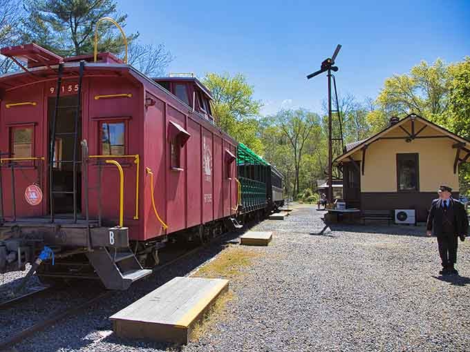 That cherry-red caboose against spring green trees creates a postcard moment you'll want to frame forever.