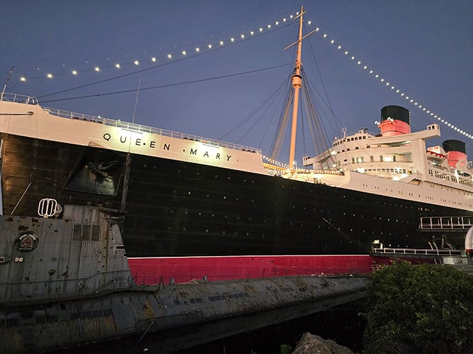 This Art Deco ocean liner stretches majestically along the dock, her glory days still visible beneath the twinkling evening lights.