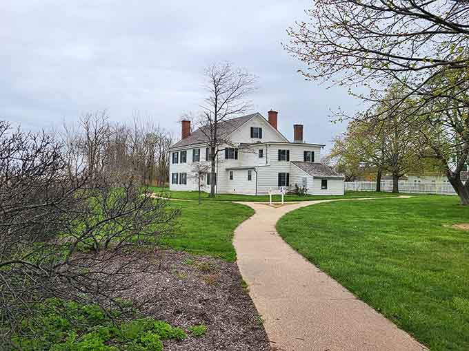 The spring landscape frames this historic home beautifully, though its reputation for ghostly encounters adds delicious intrigue to visits.