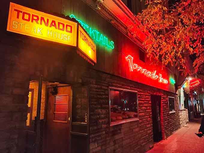 That classic neon beckons like a lighthouse for hungry travelers seeking perfectly charred beef and old-school hospitality.