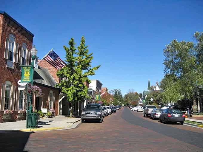 Brick streets and American flags create a timeless scene where history meets everyday life beautifully.