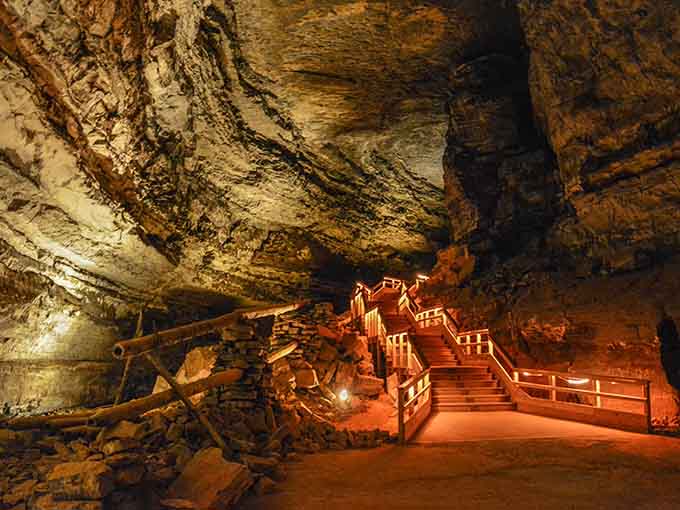 Inside Mammoth Cave, wooden walkways wind through chambers so vast cathedrals would feel inadequate by comparison.