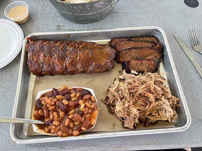 Ribs, brisket, pulled pork, and beans on one tray: basically the Mount Rushmore of barbecue.
