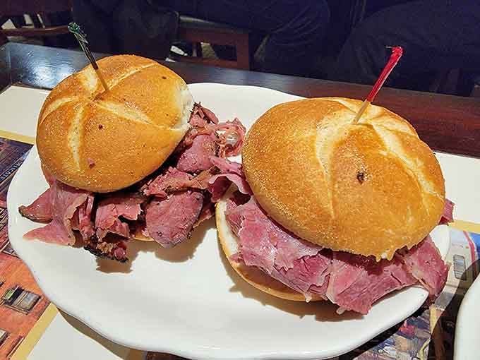 Two kaiser rolls barely contain the meat avalanche within, proving bigger is definitely better in deli mathematics.