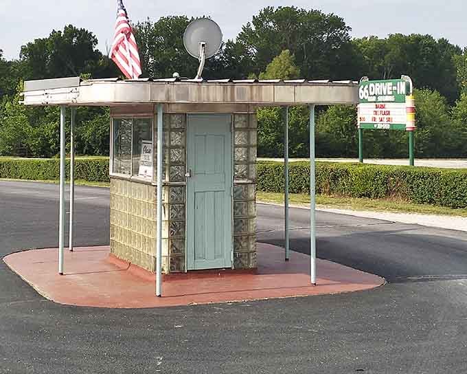 The vintage ticket booth with its glass block walls and patriotic flag represents everything charming about mid-century American design.