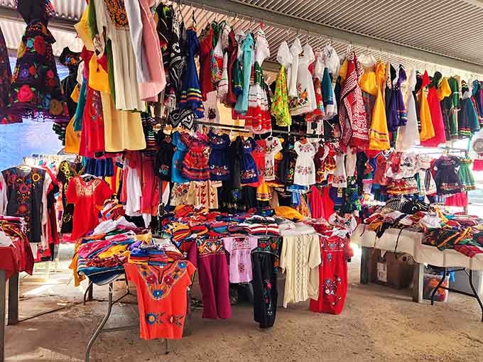 Traditional embroidered dresses hang like a vibrant fiesta frozen in time, waiting for their next celebration.