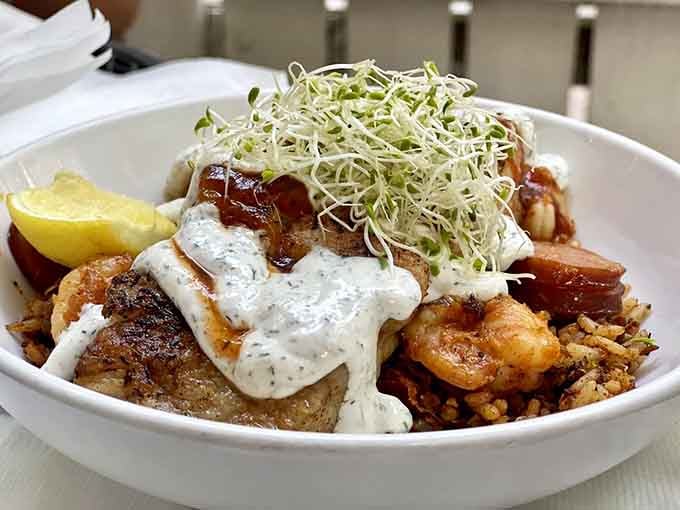 Seafood purloo topped with fresh sprouts proves that comfort food can be both hearty and surprisingly elegant simultaneously.