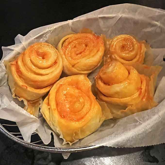 Behold the legendary orange rolls, glistening with buttery glory and ready to derail your dinner plans completely.