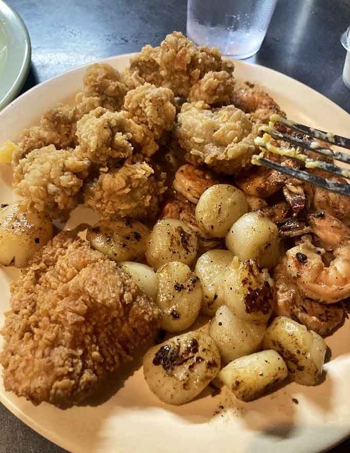 Golden fried oysters meet perfectly seasoned shrimp and grilled scallops in a seafood lover's dream come true on one plate.