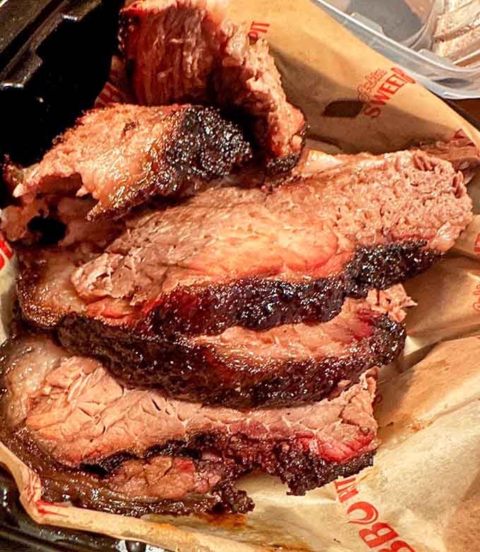 Look at that bark, that smoke ring, that perfect tenderness. This is brisket that dreams are made of.