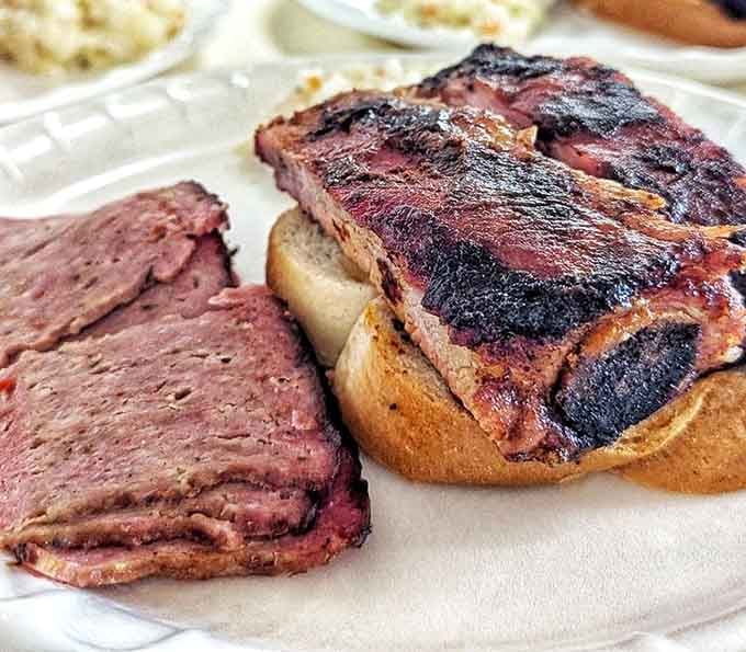 Brisket and ribs on white bread &ndash; sometimes the simplest presentation delivers the most profound flavor experience.