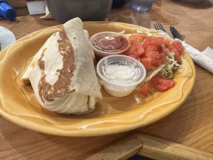 That wrap is stuffed tighter than a suitcase before a two-week vacation, with fresh tomatoes peeking out temptingly.