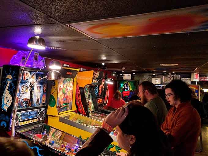The ceiling's psychedelic swirl perfectly matches the sensory overload happening at every machine below it all.