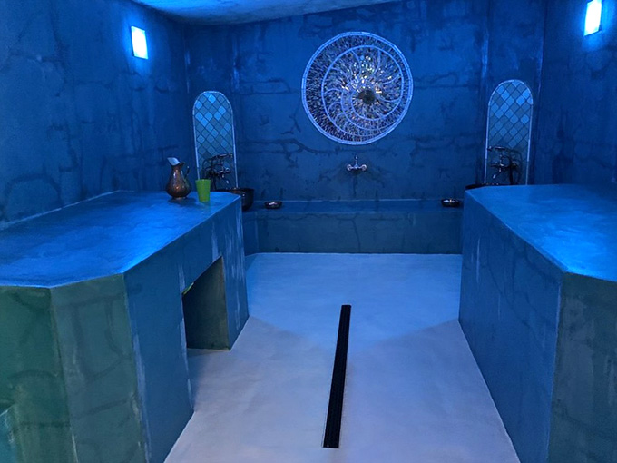 This Turkish-style hammam bathed in blue light looks like a spa from another dimension entirely.