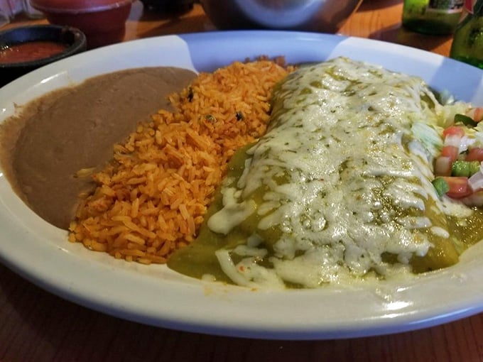 That creamy green sauce cascading over enchiladas looks like edible velvet, rich and impossibly smooth against golden tortillas.