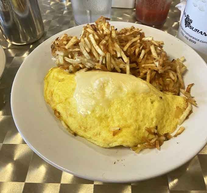 That omelet is so perfectly golden and fluffy, it could make a French chef weep with joy.