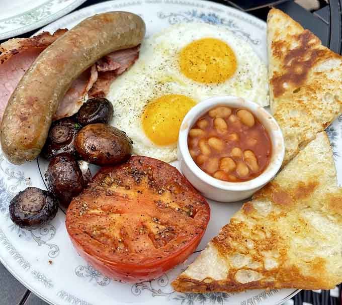 This full English breakfast comes with sausage, eggs, mushrooms, beans, and tomato that'll fuel any grand adventure ahead.