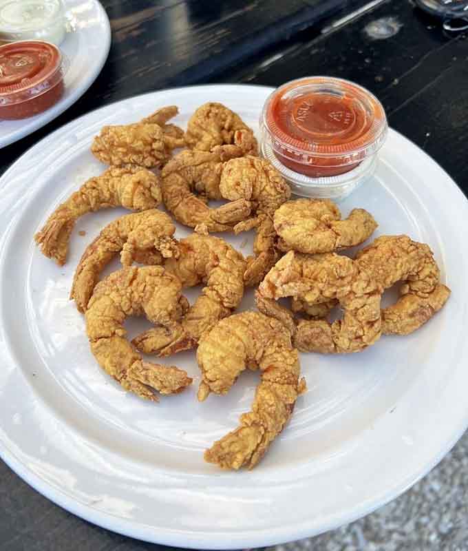 Golden fried shrimp with that perfect crunch factor, proving that sometimes the simplest preparations are the most satisfying ones.