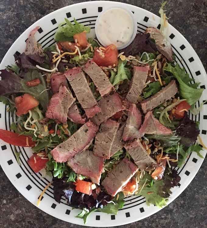 Sliced tri-tip over fresh greens proves that salad can be just as exciting as any sandwich.